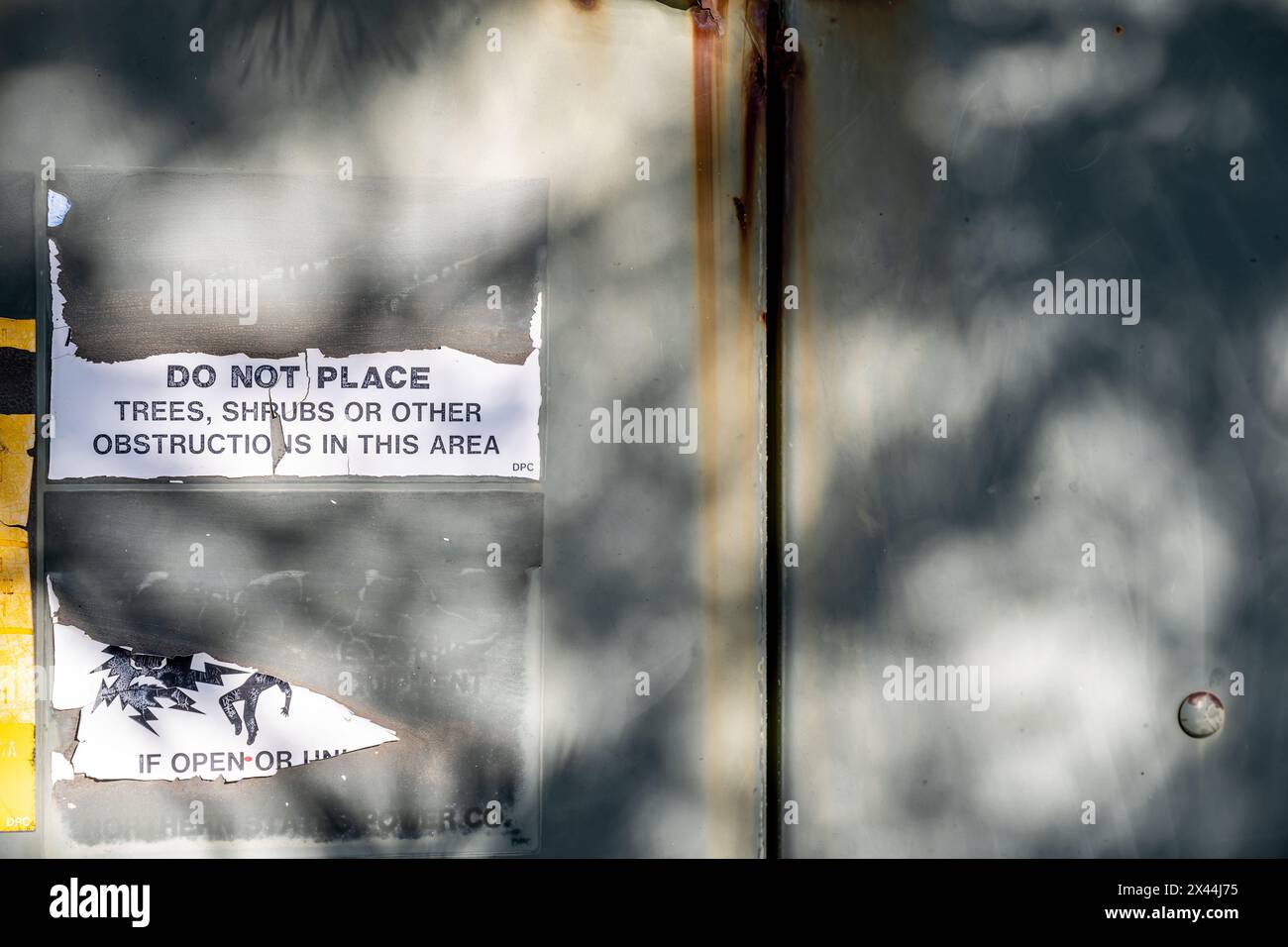 Rusted, peeling paint and warning sticker on an electrical transformer ...