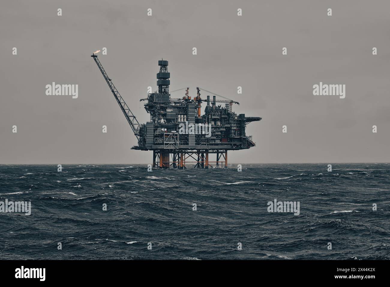 View of offshore jackup rig on the horizon on a grey cloudy day in the ...