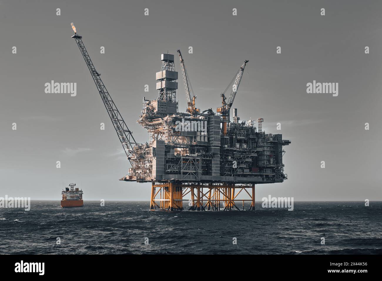 Jack up drilling rig and supply vessel in the sea with minimum colours ...