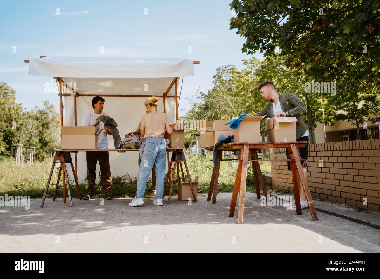 Group of male and female volunteers working together during charity ...