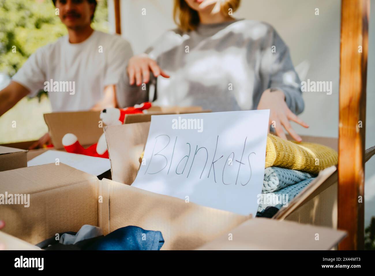 Blankets name tag near donation boxes at community center Stock Photo ...