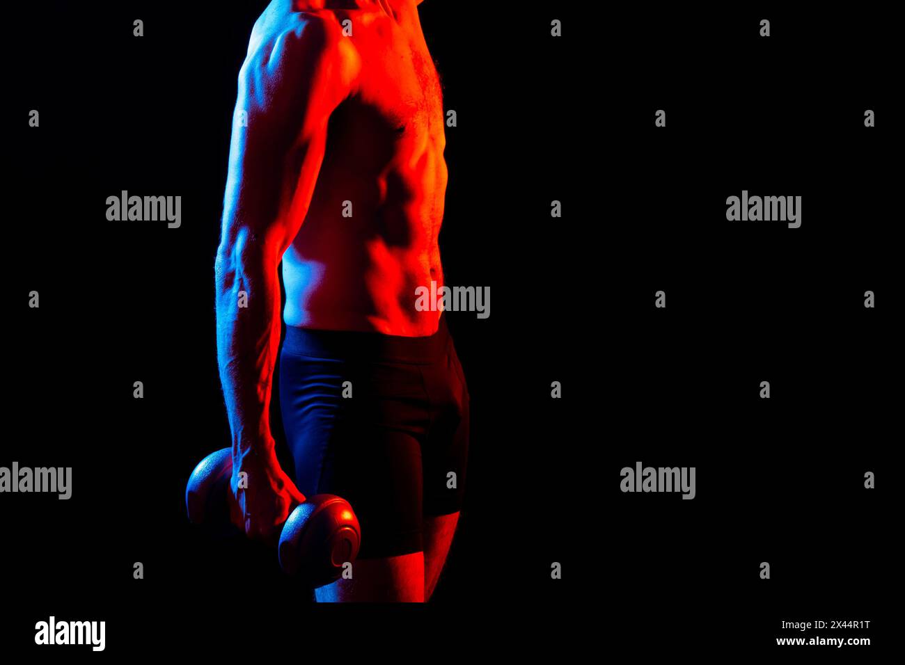 Exercising weight training man with a dumbbell isolated studio ...