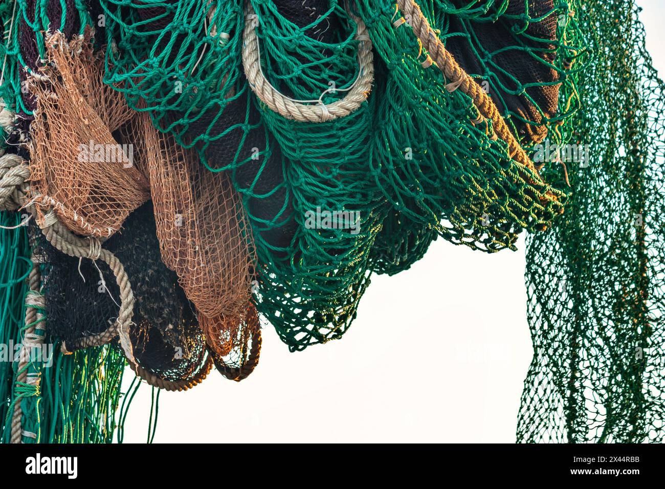 Drying fishing nets on the trawler in city harbor at sunset of the day ...