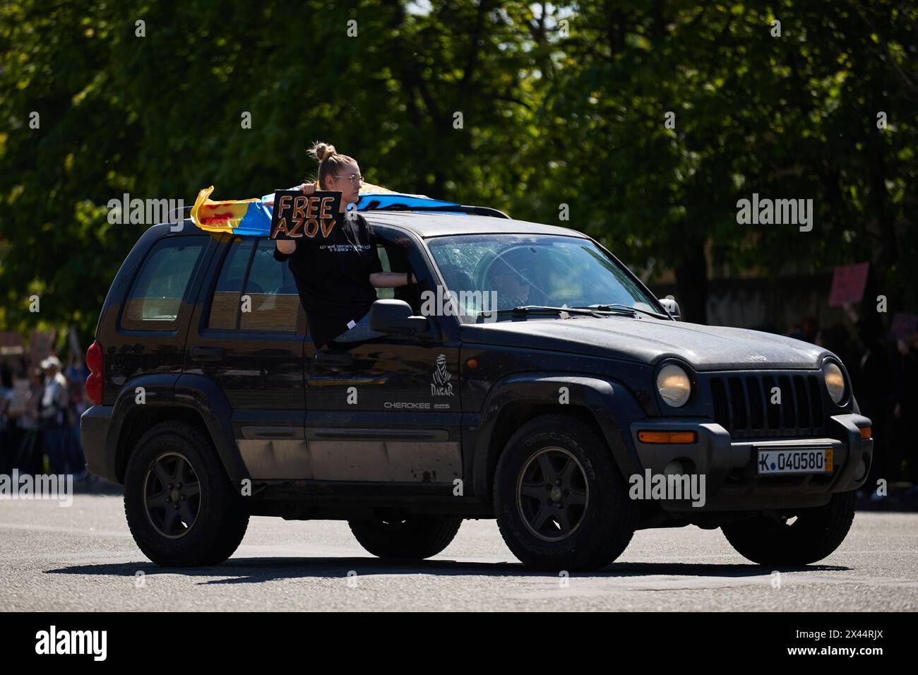 Ukrainian activist rides in a car with a sigh "Free Azov" and flag of ...