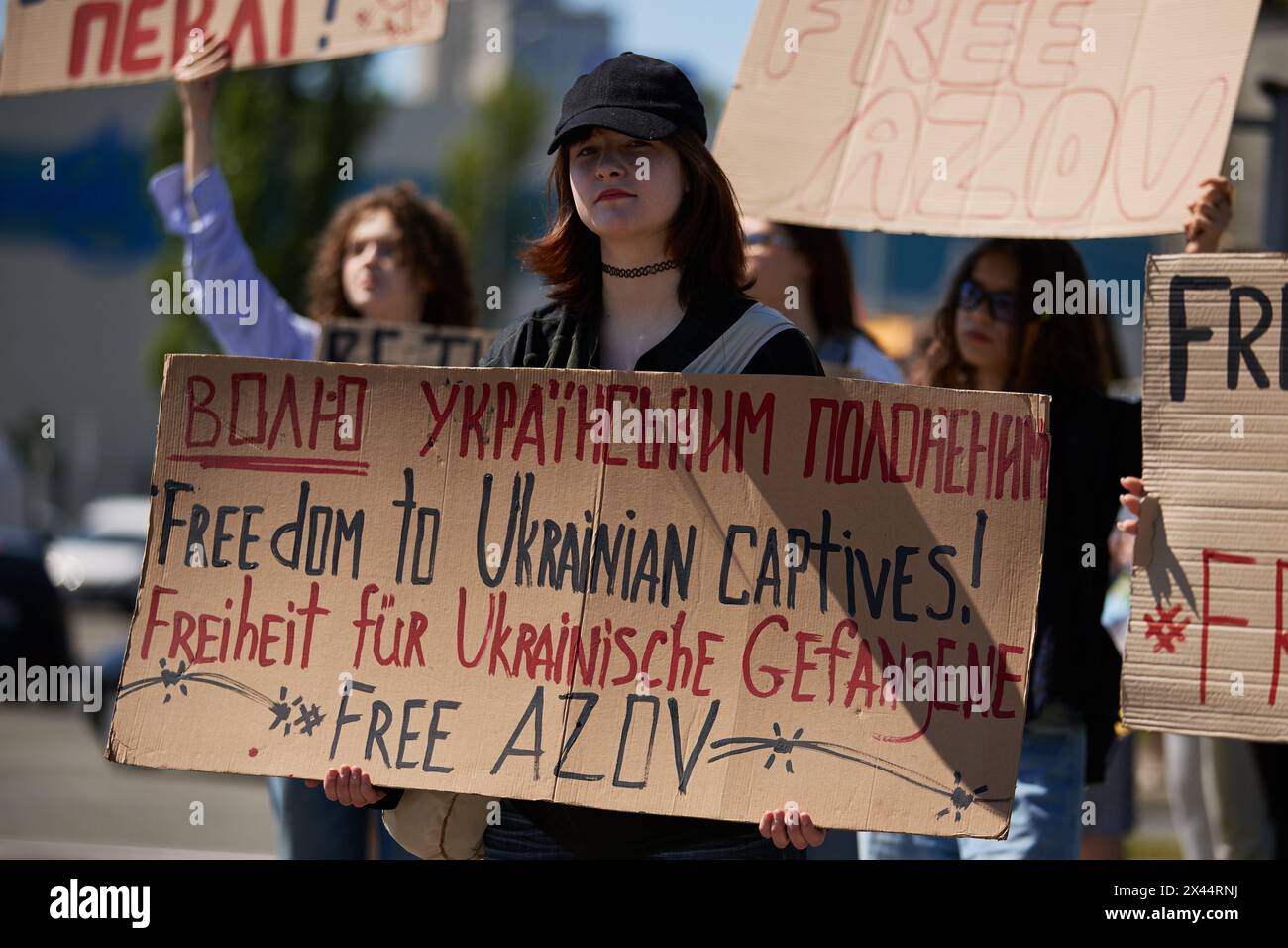Ukrainian girl holds a banner "Freedom To Ukrainian Captives. Freiheit ...