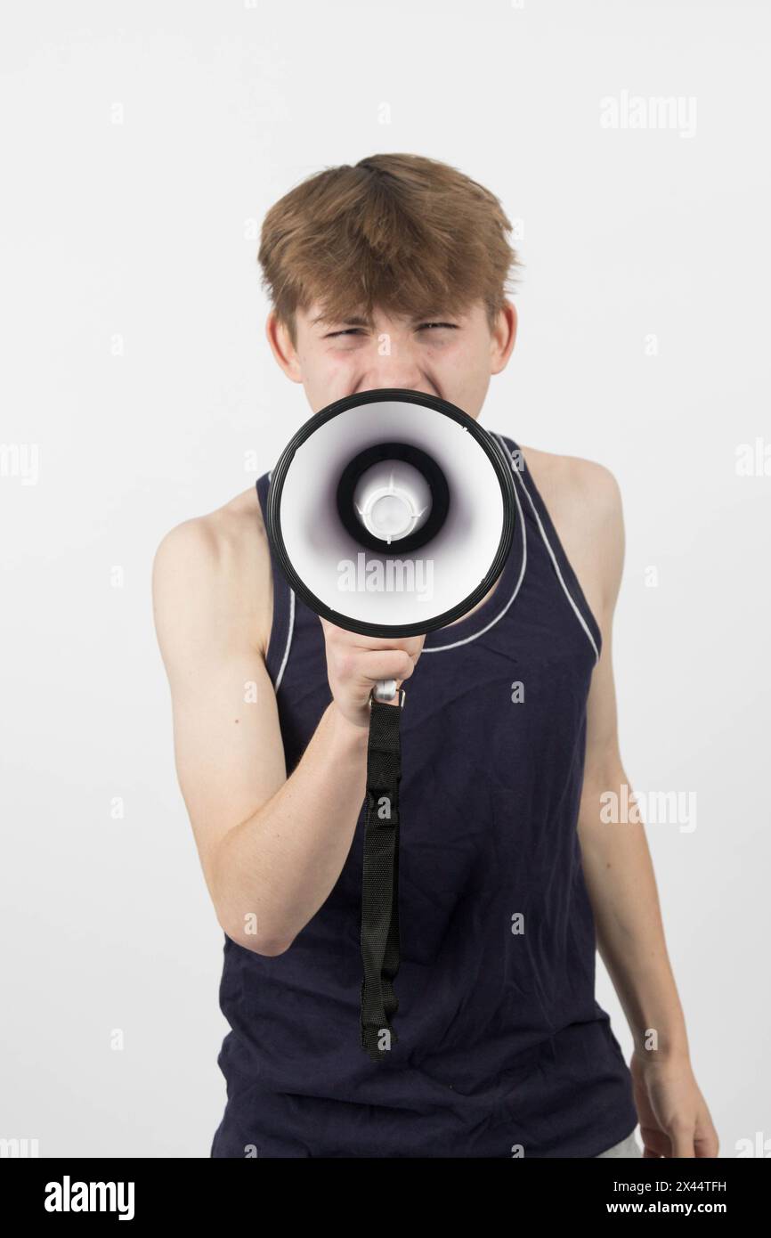 A male teenage protester with a megaphone shouting Stock Photo - Alamy