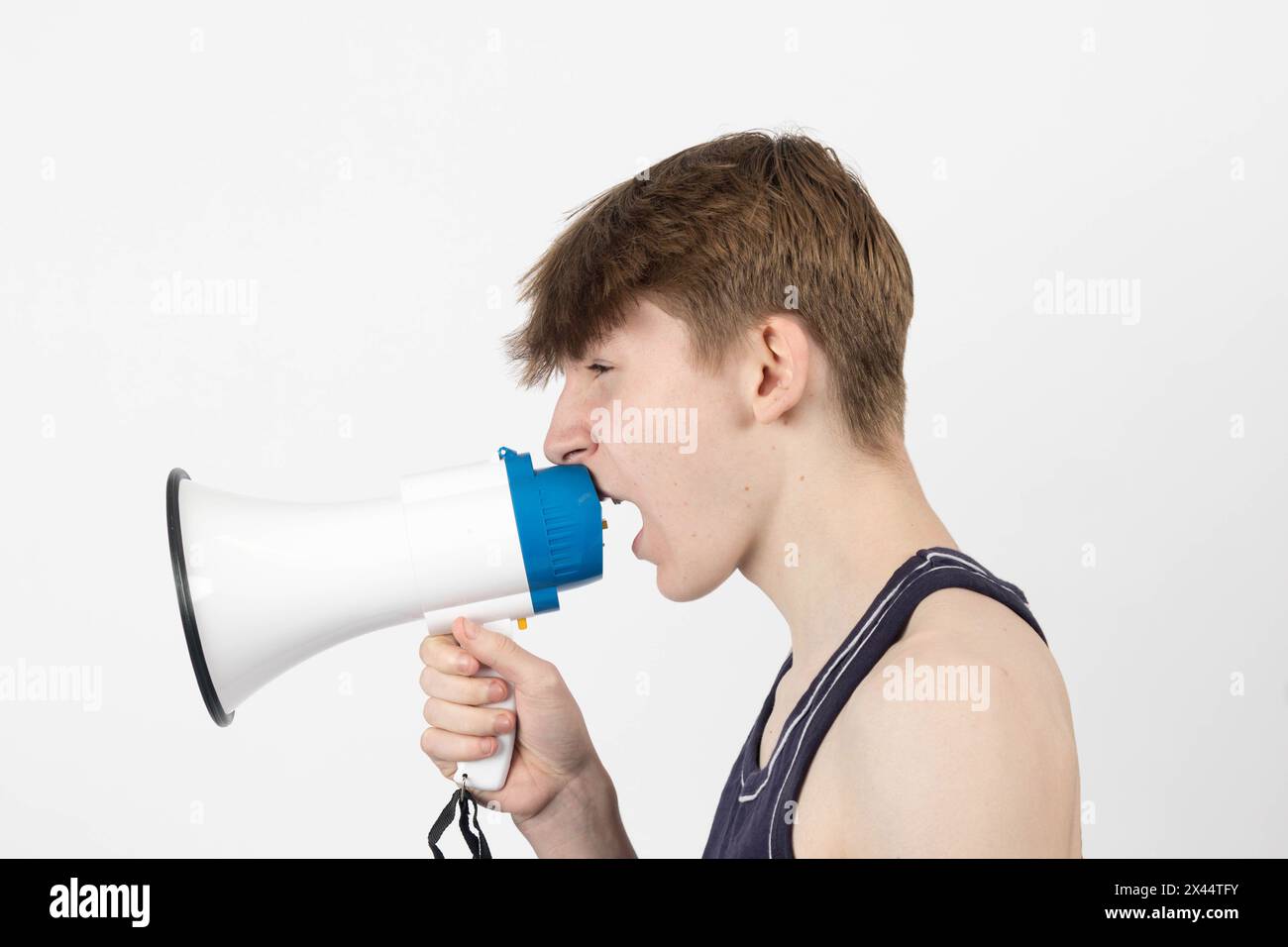 A male teenage protester with a megaphone shouting Stock Photo - Alamy