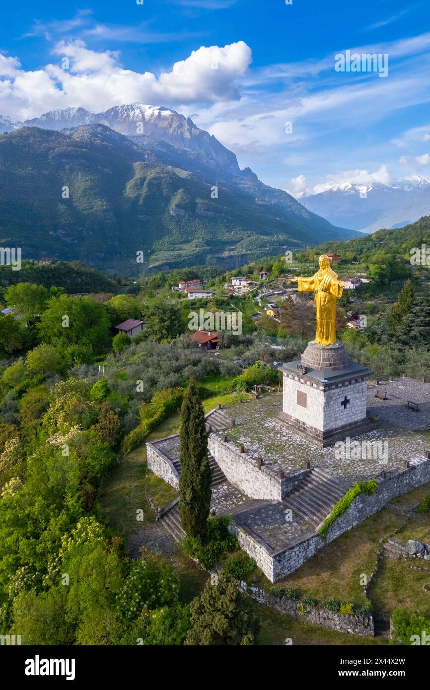 Aerial view of the golden statue of the colossus of Cristo Re. Bienno ...