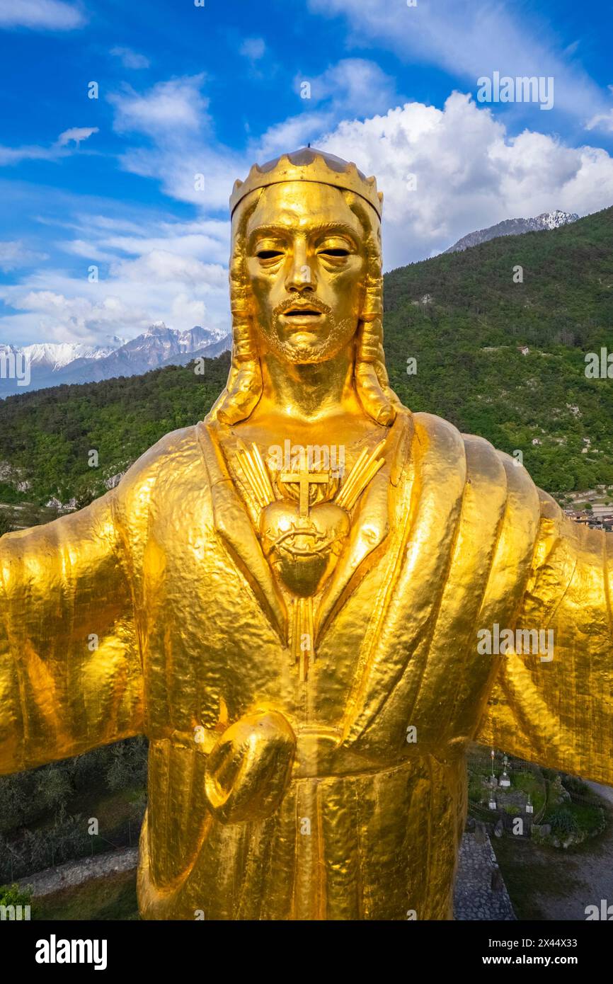 Aerial view of the golden statue of the colossus of Cristo Re. Bienno ...