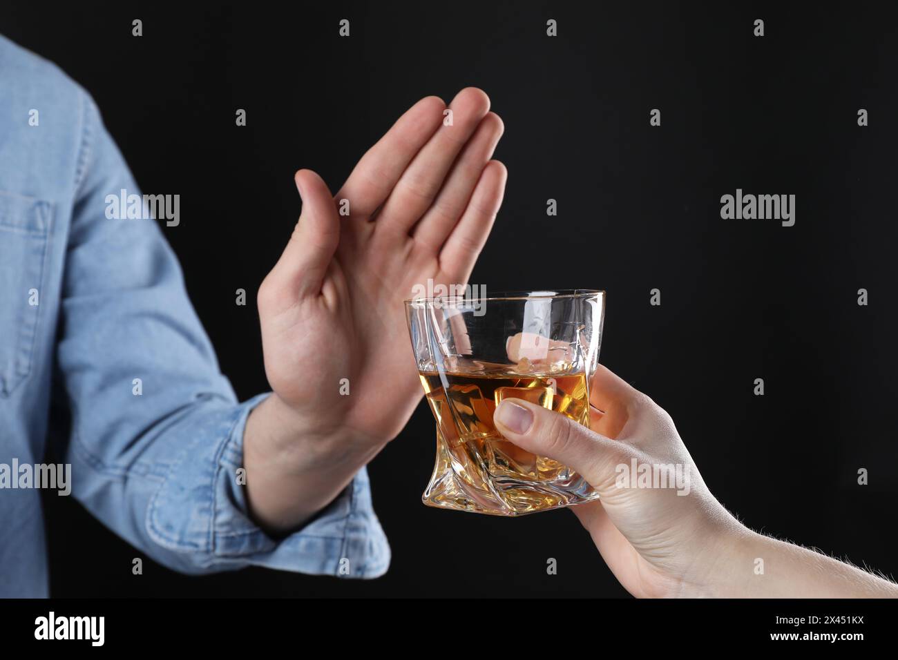 Alcohol addiction. Man refusing glass of whiskey on dark background ...
