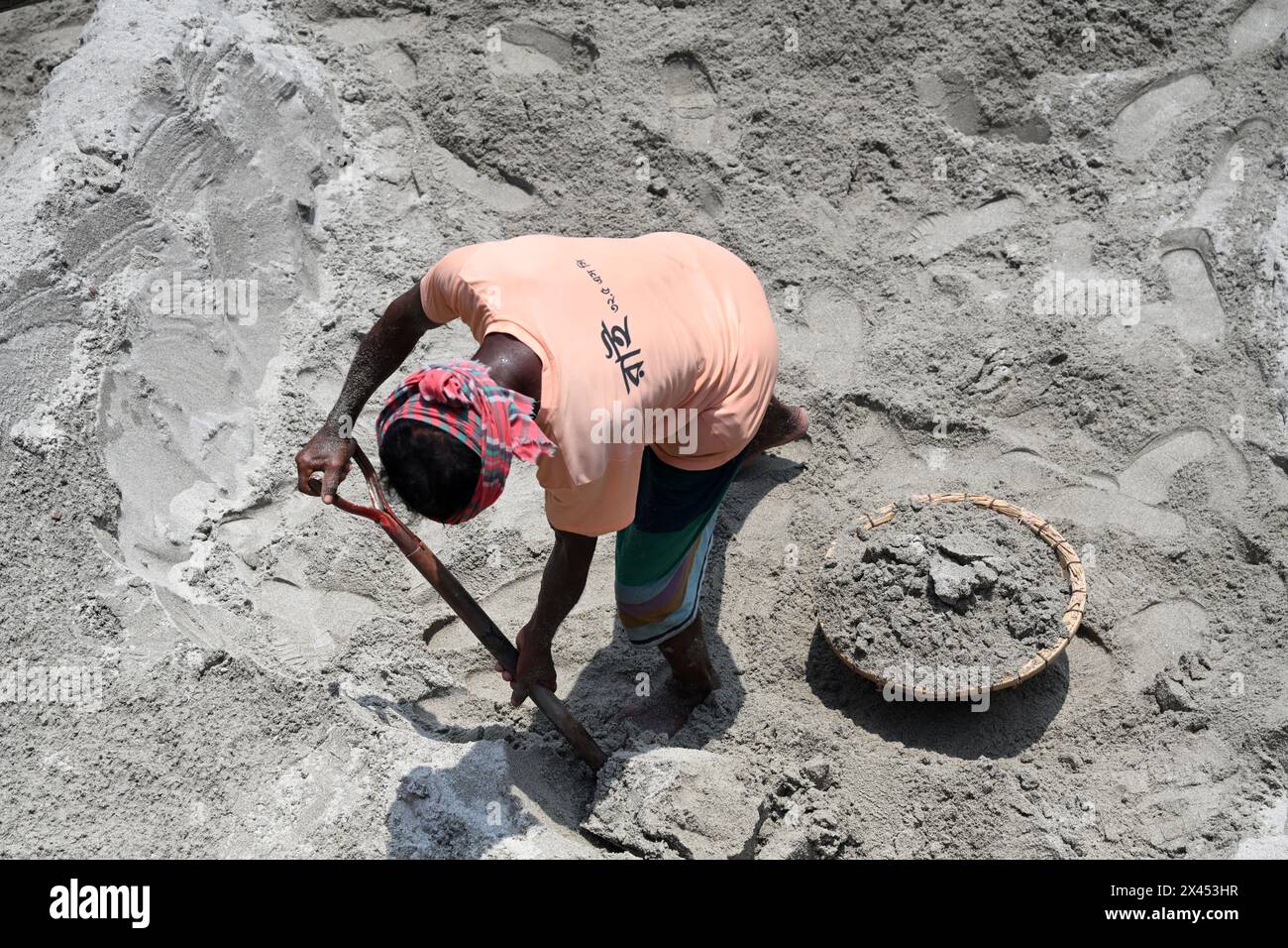 Dhaka, Bangladesh, on April 30, 2024. Workers unload sand from a cargo ...