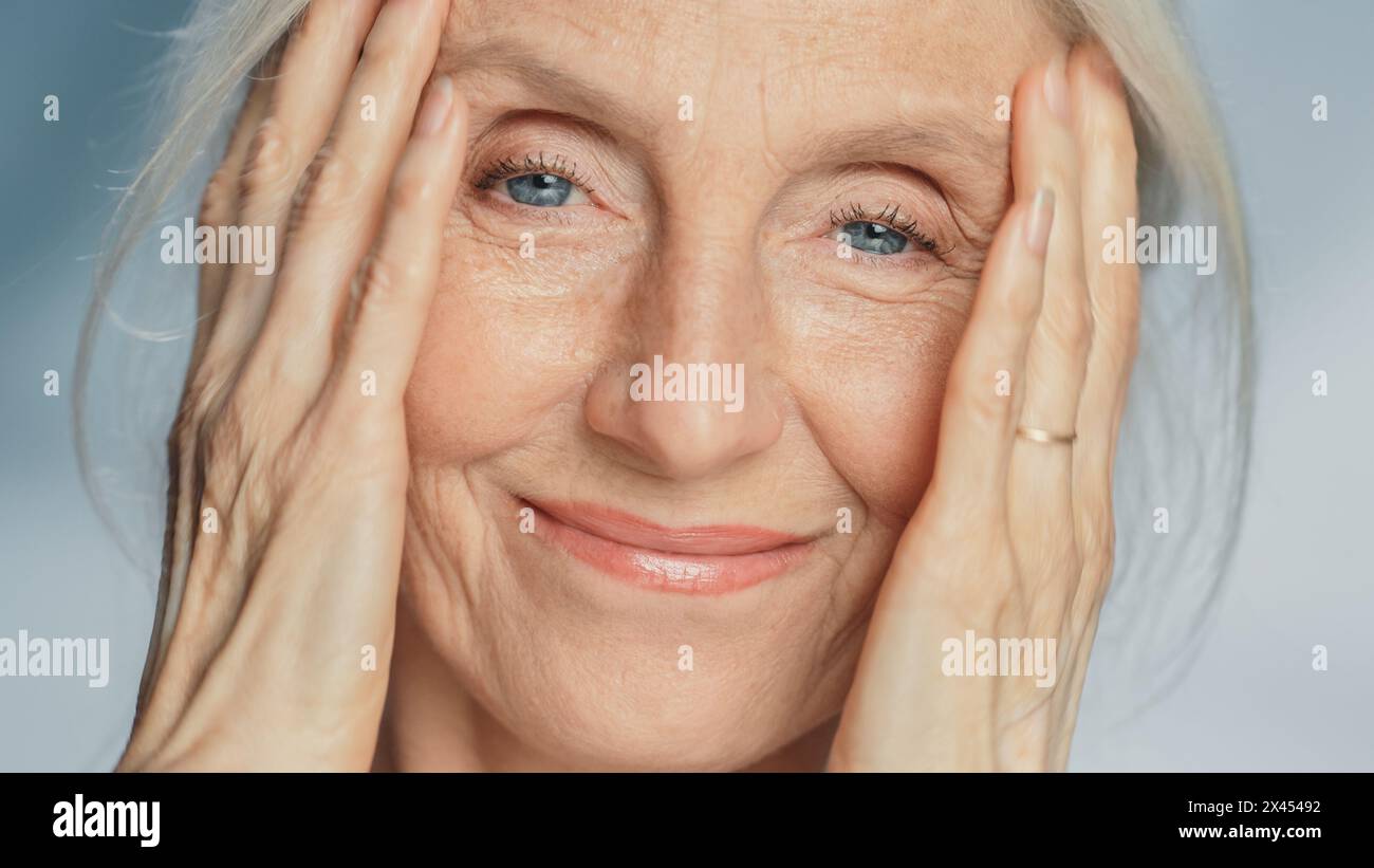 Close Up Portrait Of Beautiful Senior Woman Looking At Camera And