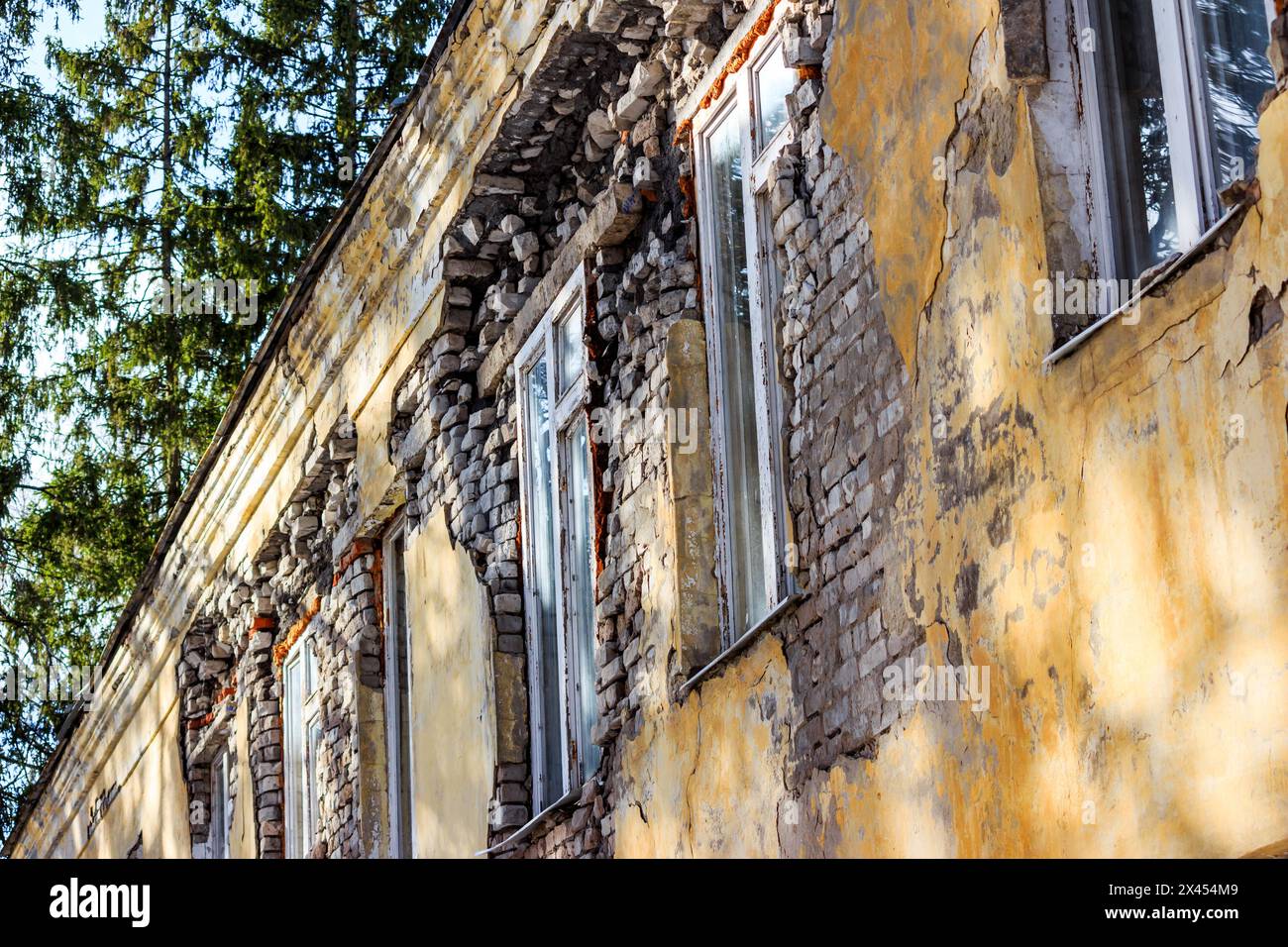 Collapsing wall of a dilapidated brick building, falling out bricks ...