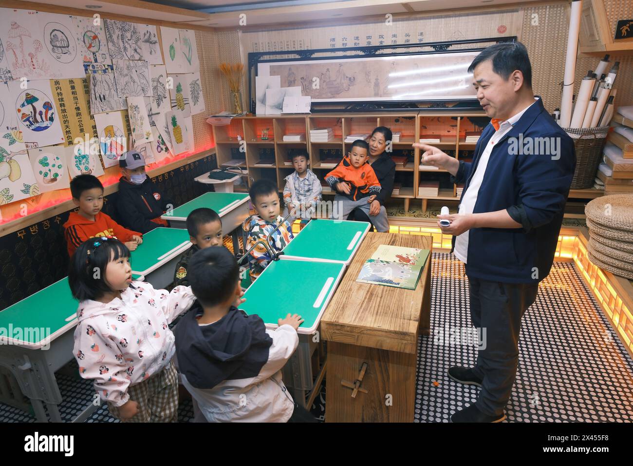 Beijing, China. 28th Apr, 2024. A voluntary teacher leads students to ...