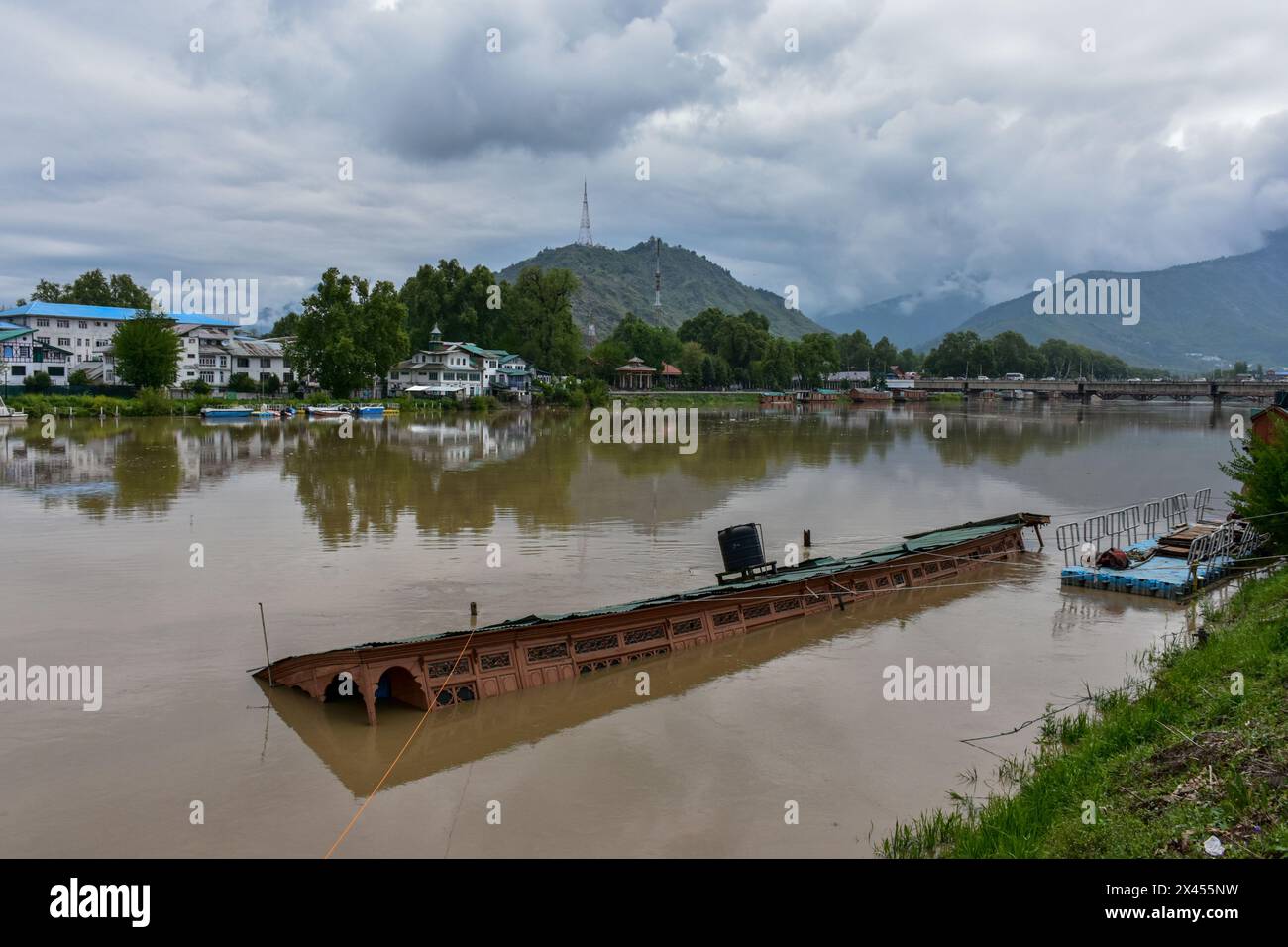 A capsized houseboat is seen in the river Jhelum flowing over the flood ...