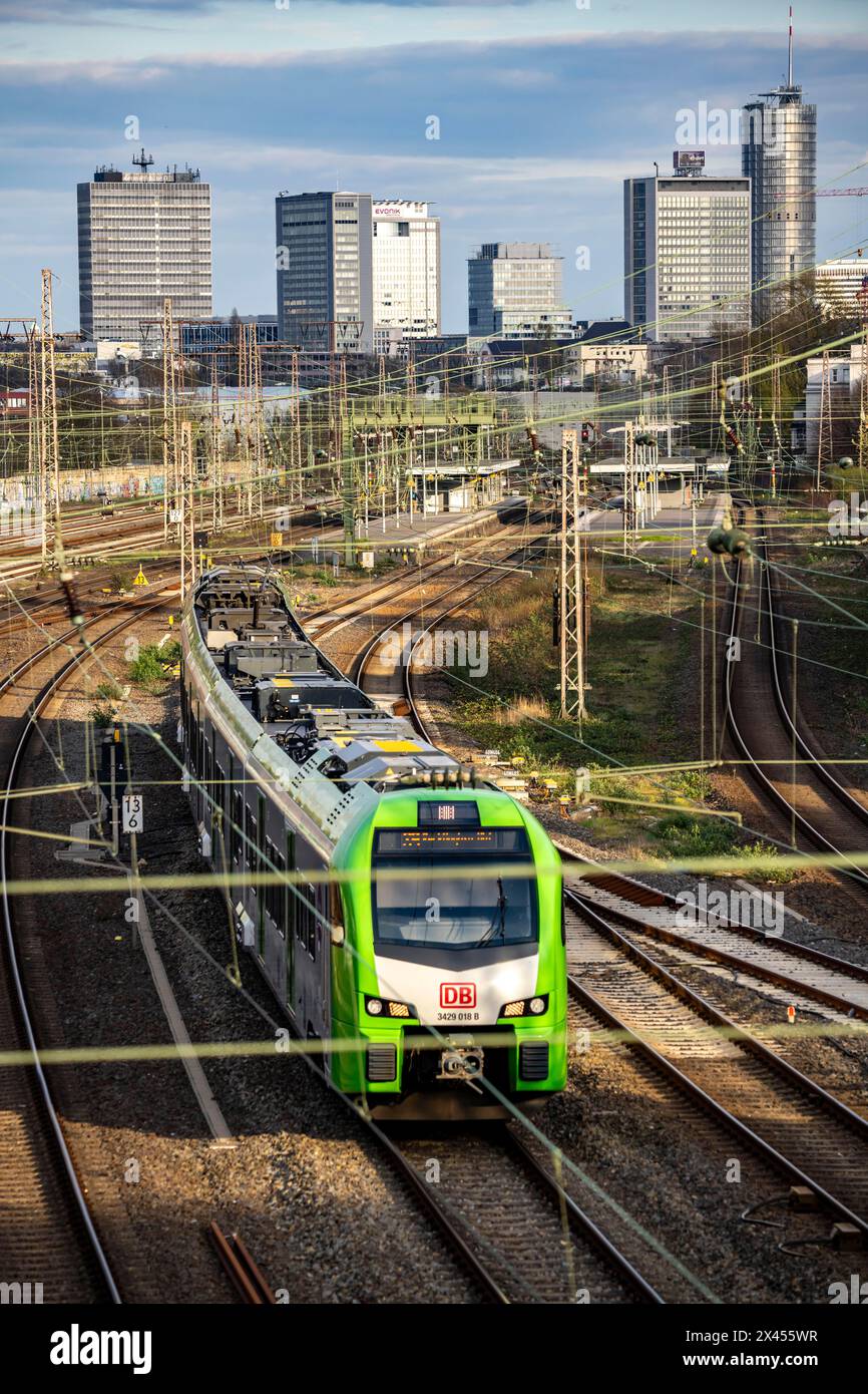 Train on the tracks west of the main station of Essen, skyline of the ...