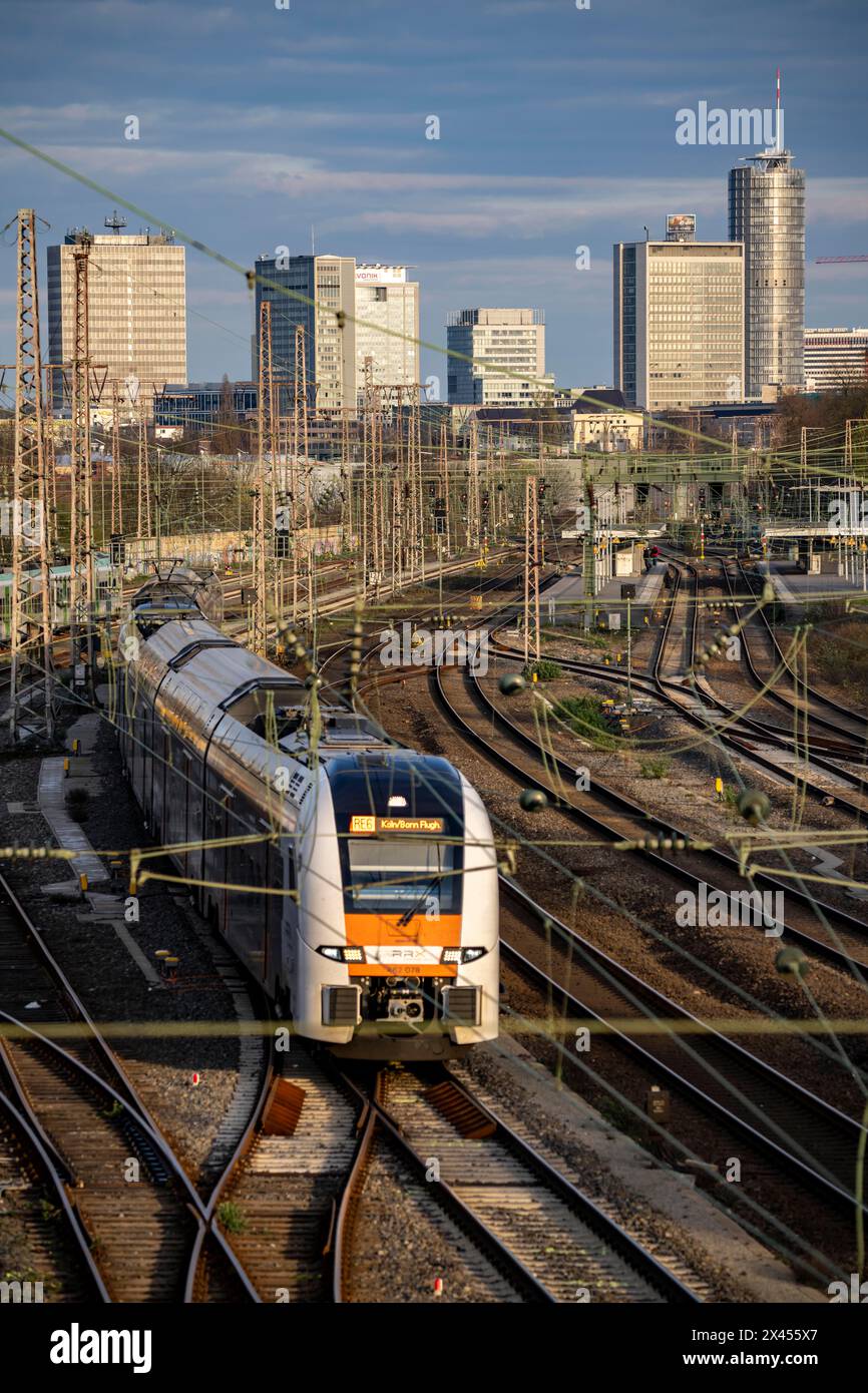 Train on the tracks west of the main station of Essen, skyline of the ...