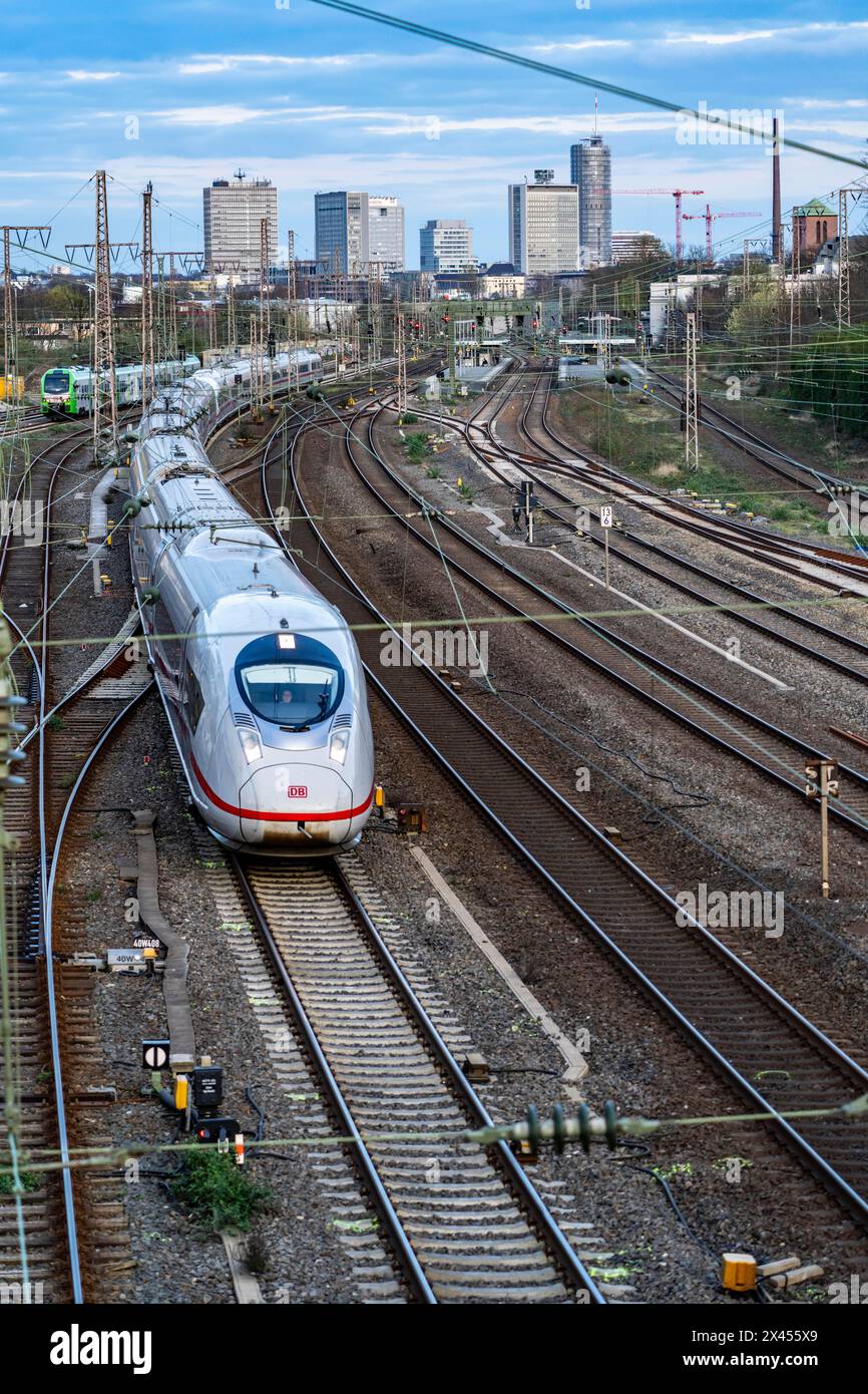 Train on the tracks west of the main station of Essen, skyline of the ...