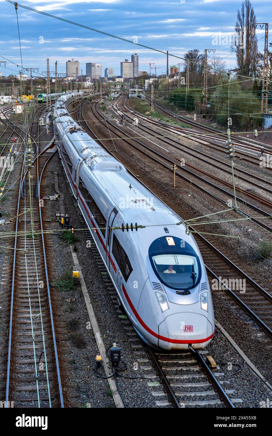 Train on the tracks west of the main station of Essen, skyline of the ...