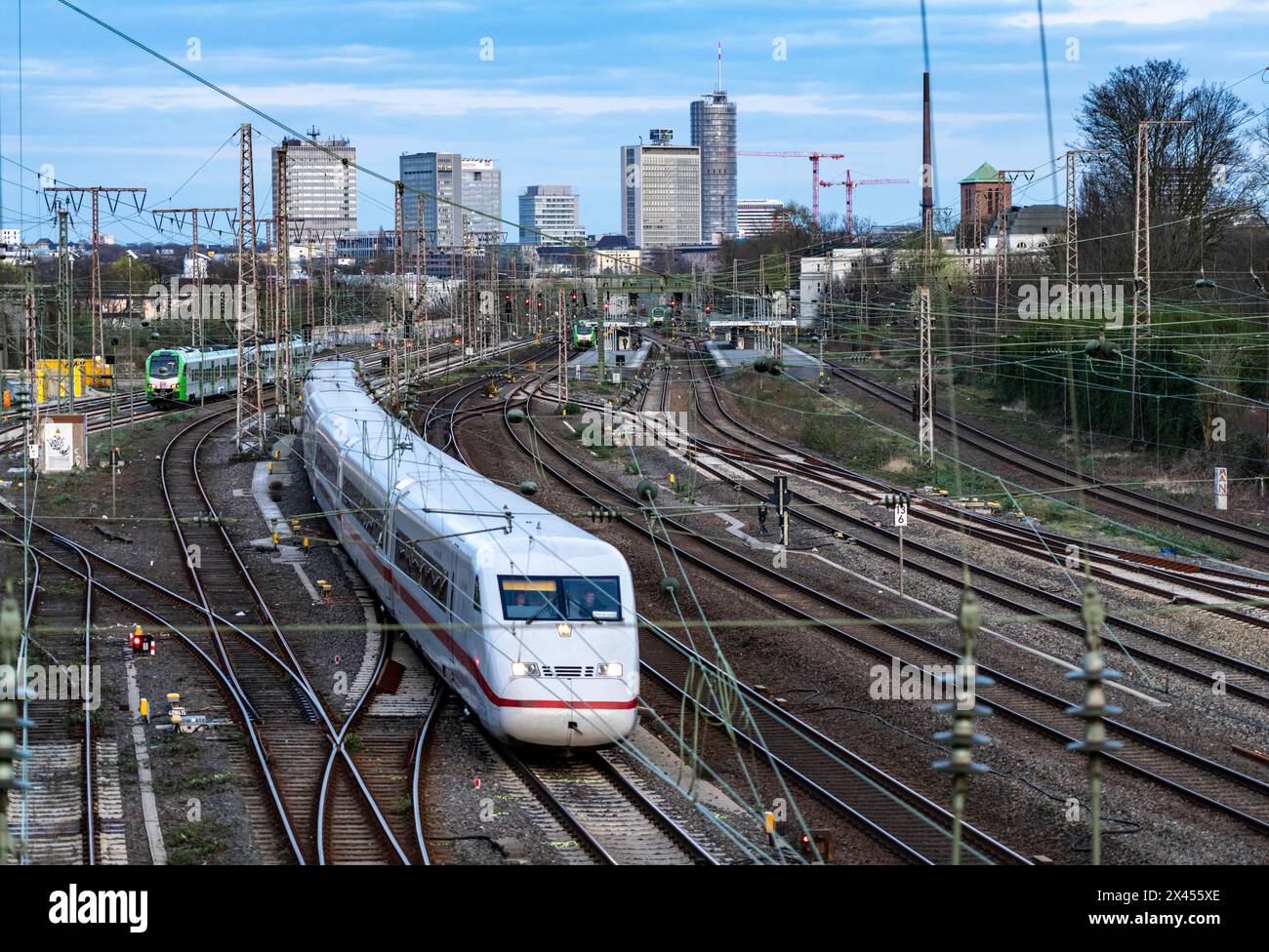Train on the tracks west of the main station of Essen, skyline of the ...