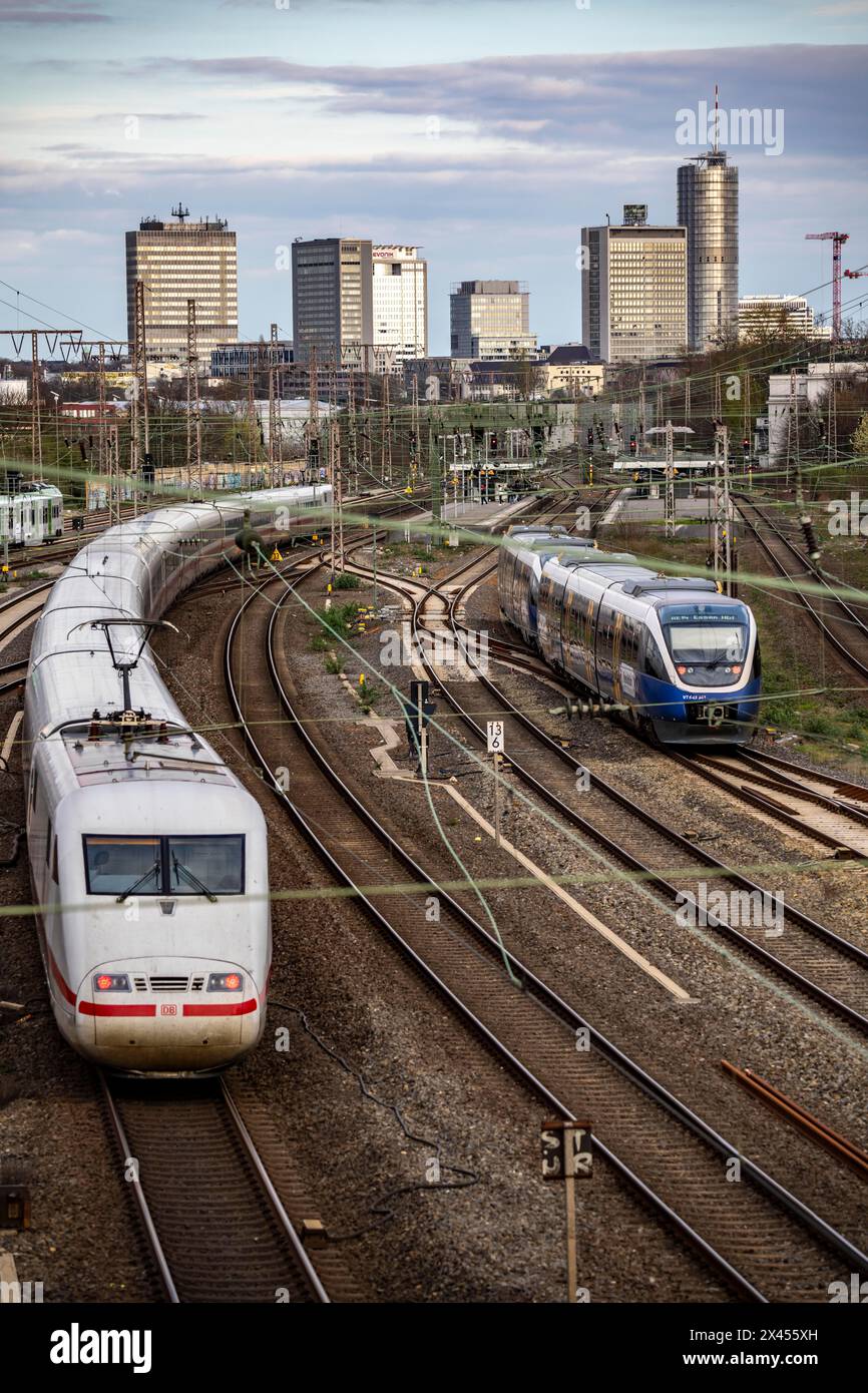 Train on the tracks west of the main station of Essen, skyline of the ...