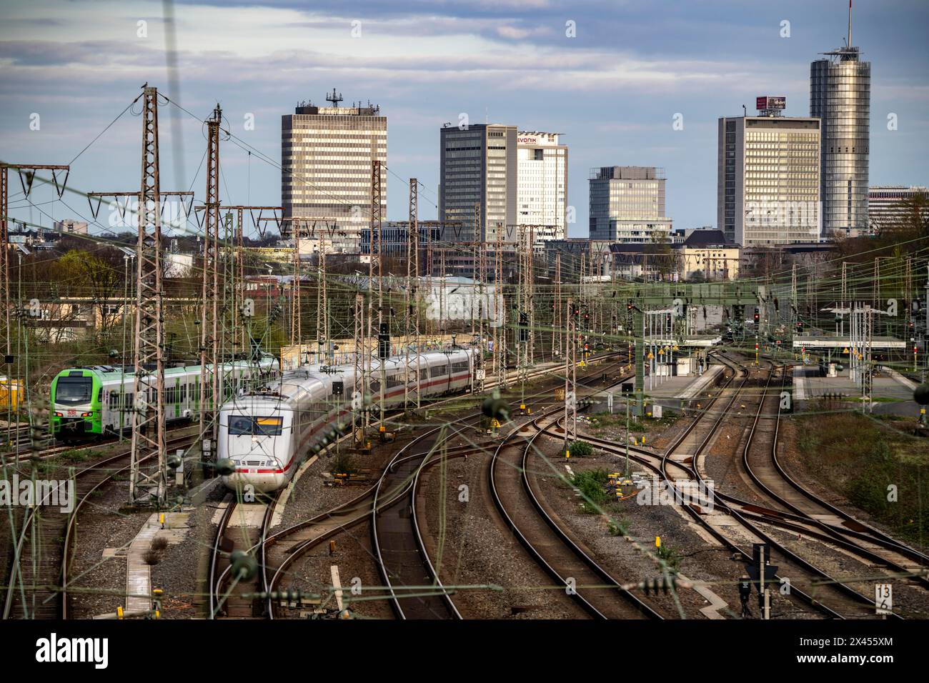 Train on the tracks west of the main station of Essen, skyline of the ...