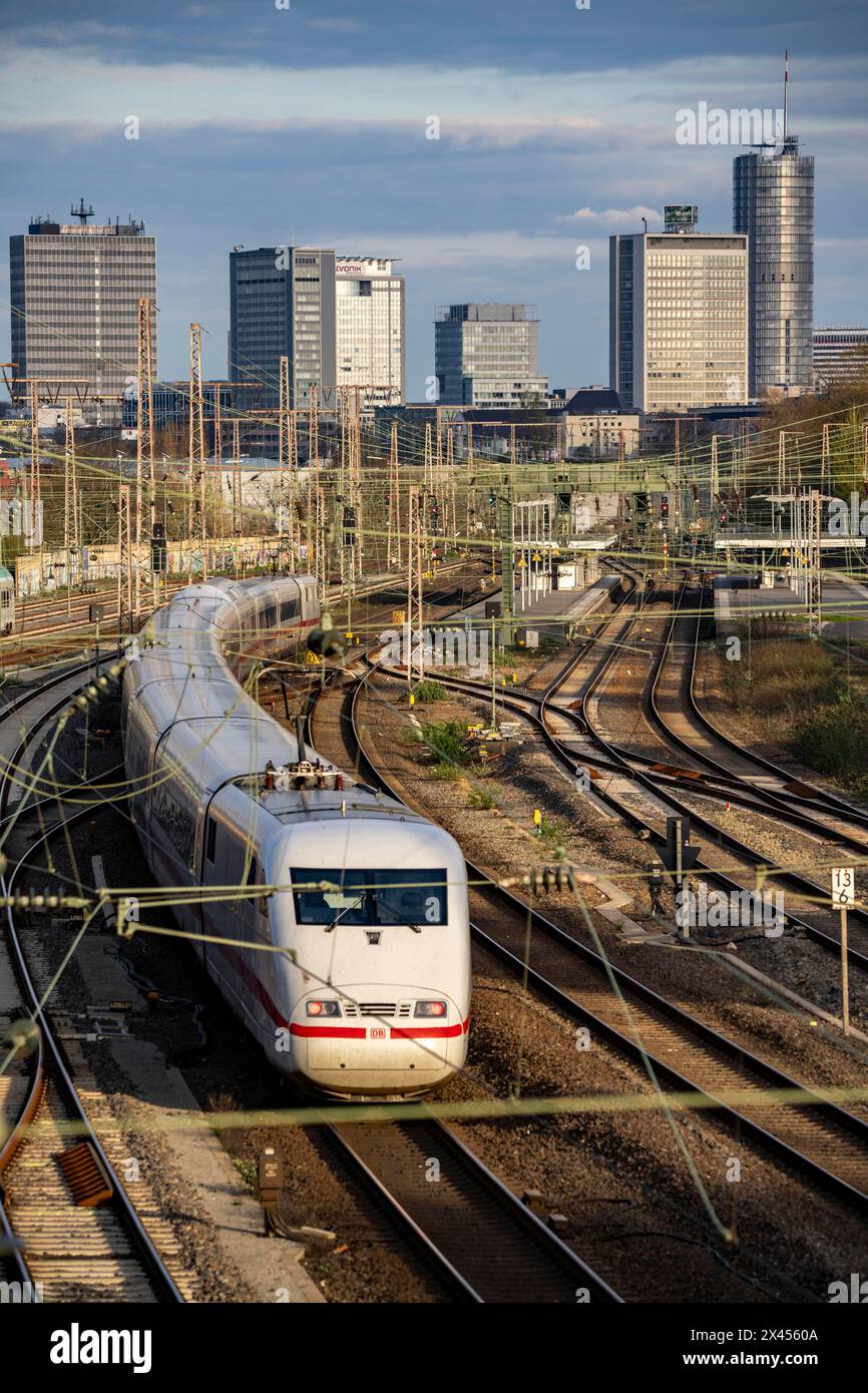Train on the tracks west of the main station of Essen, skyline of the ...