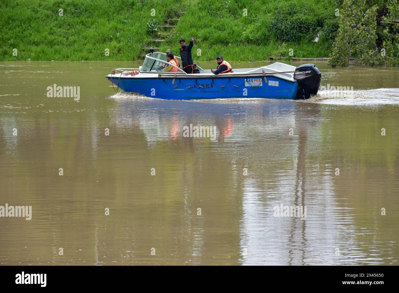 Members of the State Disaster Response Force (SDRF) patrol in a motor ...