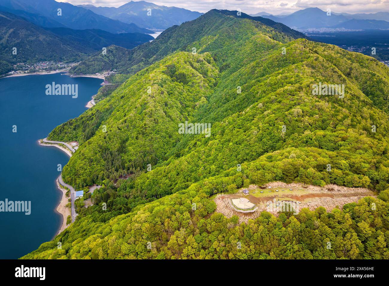 Aerial view of lush forest, mountains and an observation point above a ...