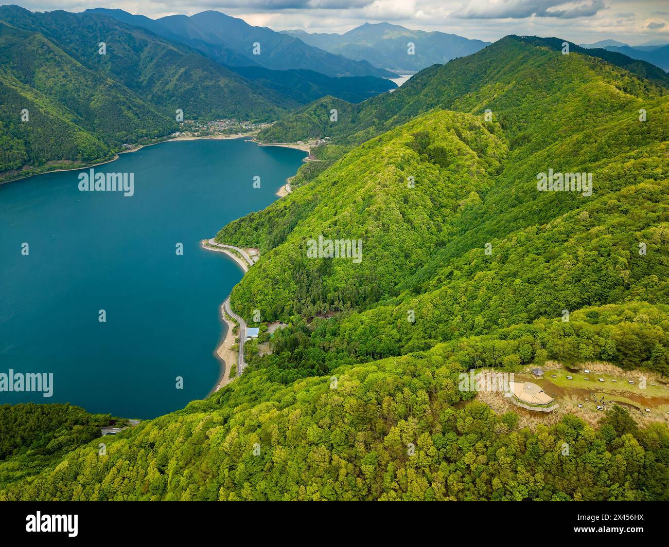 Aerial view of lush forest, mountains and an observation point above a ...