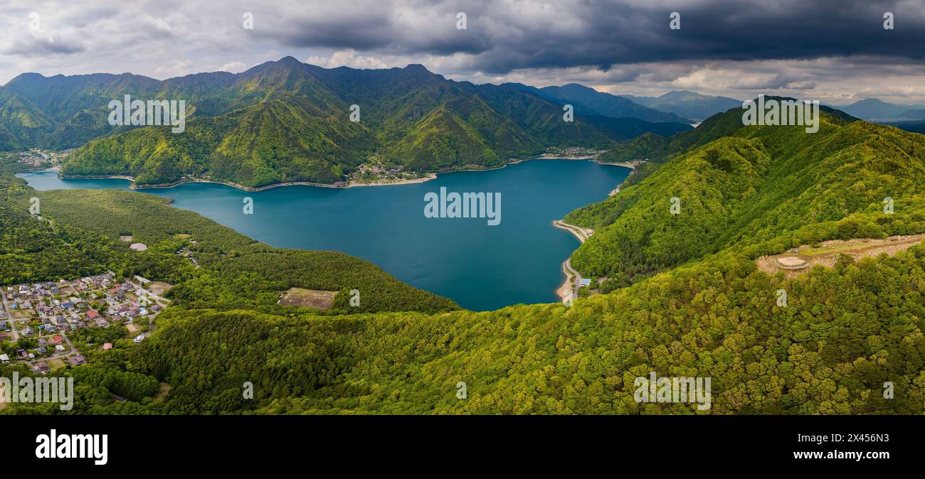 Panoramic aerial view of a lake surrounded by rugged mountains and ...