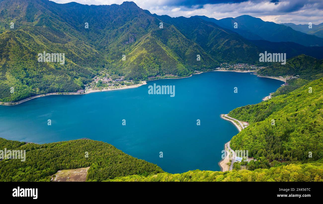 Aerial view of lush green forest surrounding a volcanic lake (Lake ...