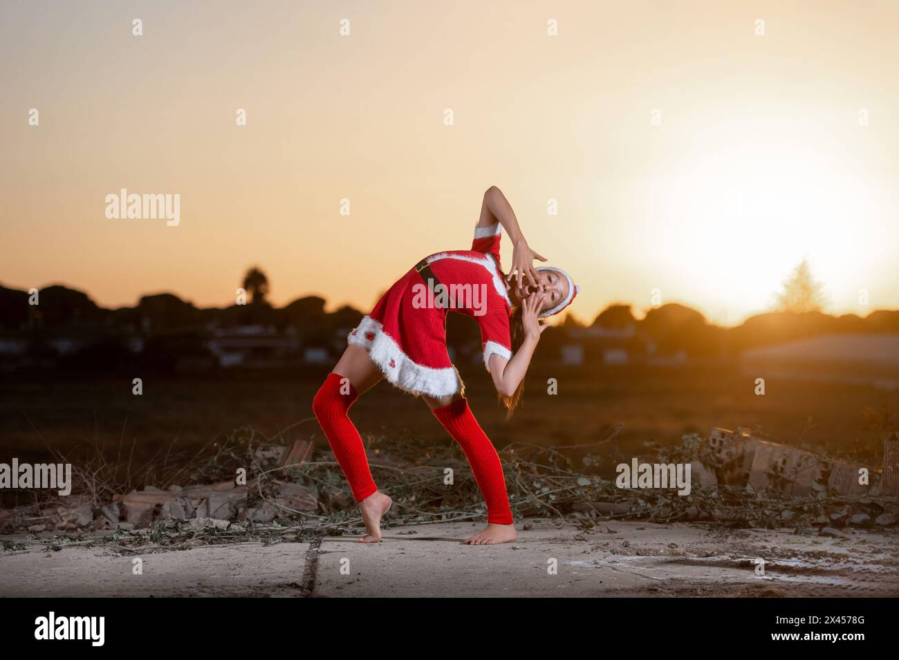 young girl performing rhythmic gymnastics exercises wearing santa claus ...