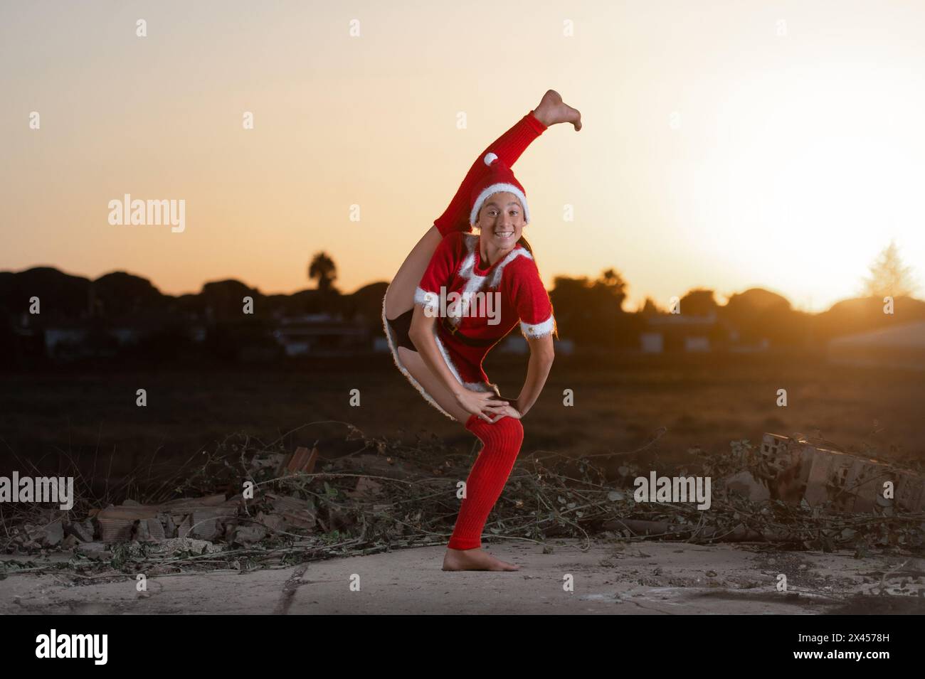 young girl performing rhythmic gymnastics exercises wearing santa claus ...