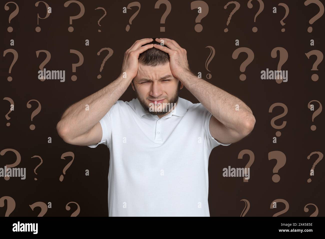 Amnesia. Confused man and question marks on brown background Stock ...