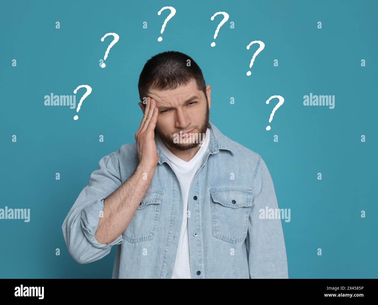 Amnesia. Confused man and question marks on light blue background Stock ...