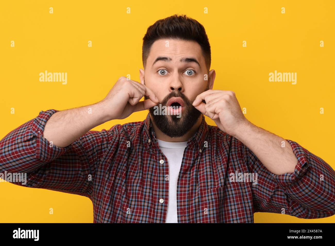 Touching his mustache hi-res stock photography and images - Alamy