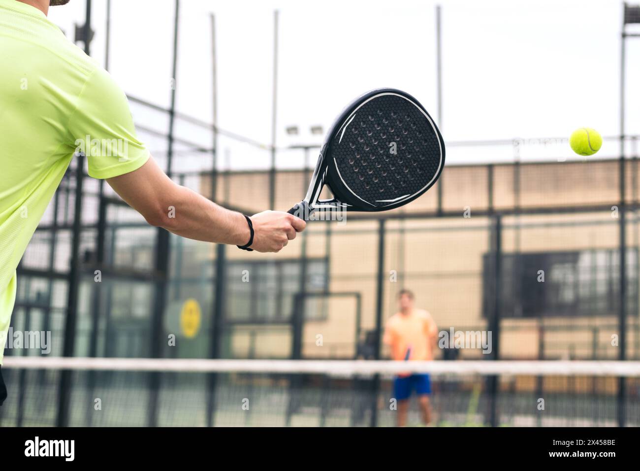 back view of a man playing paddle tennis Stock Photo - Alamy