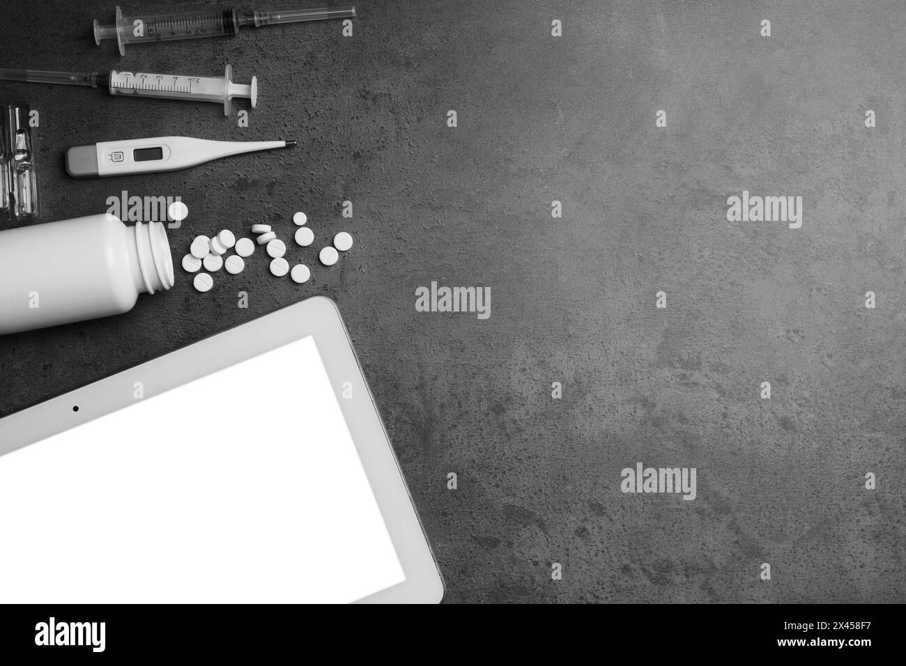Flat lay composition with modern tablet and medical supplies on grey ...