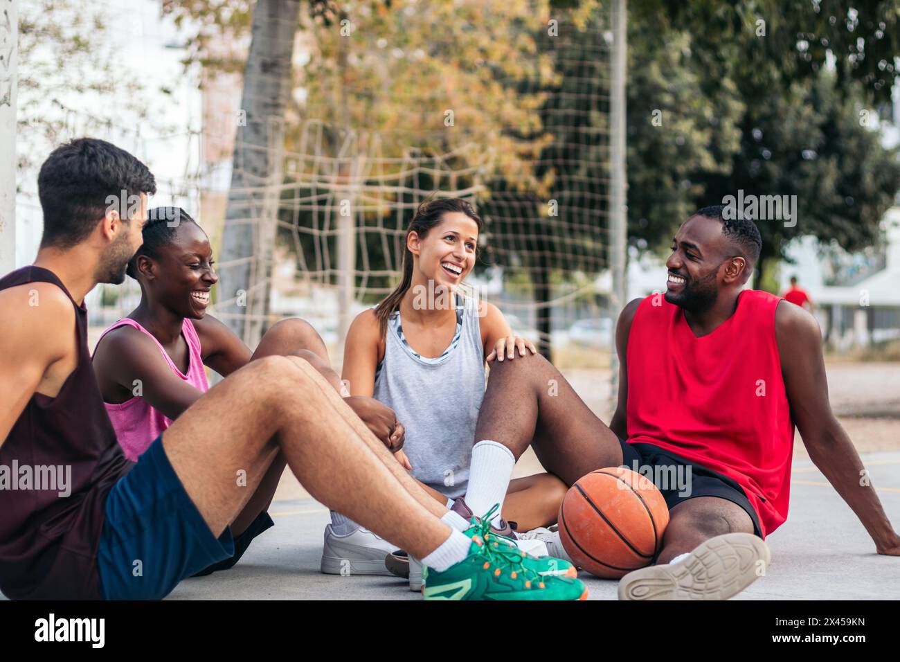 Team Bonding: Friends Sitting on Basketball Court, Chatting and ...