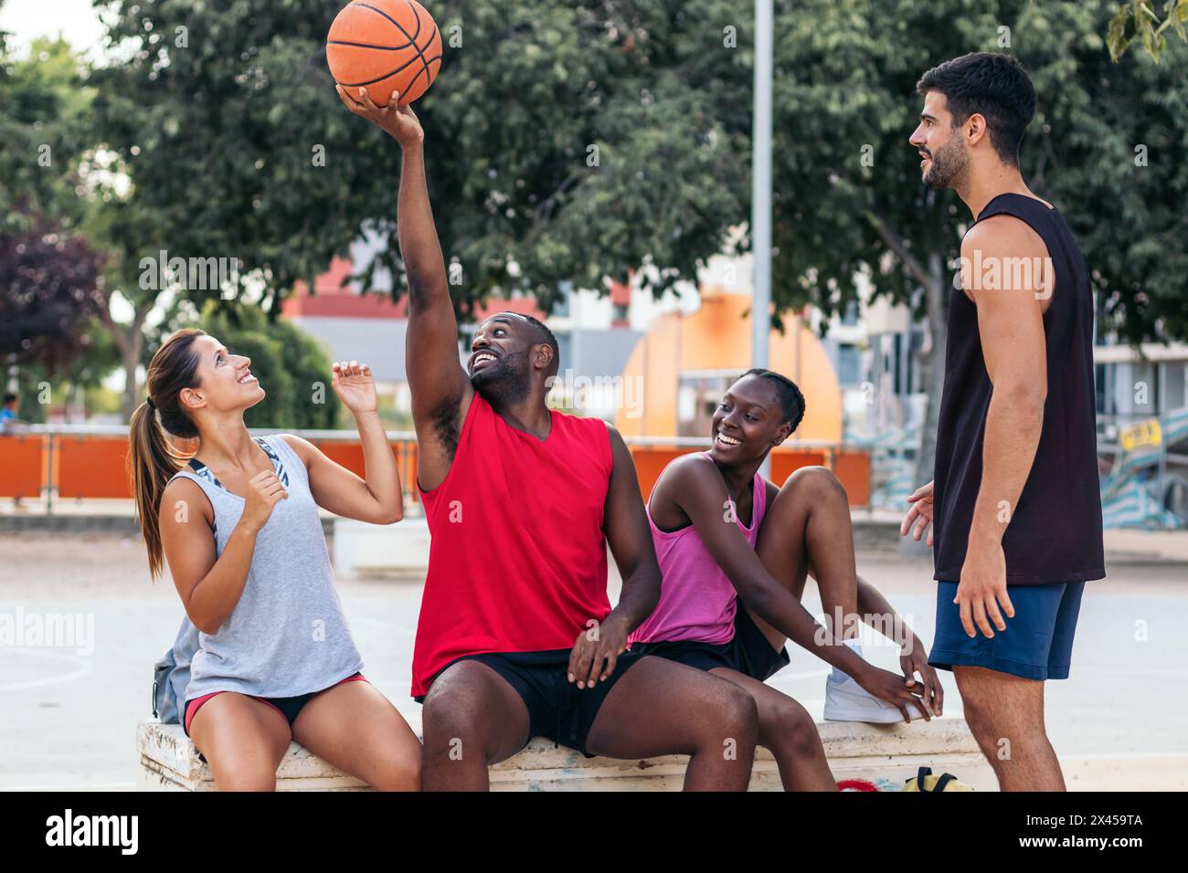 Group of interracial friends in sportswear on the basketball court ...