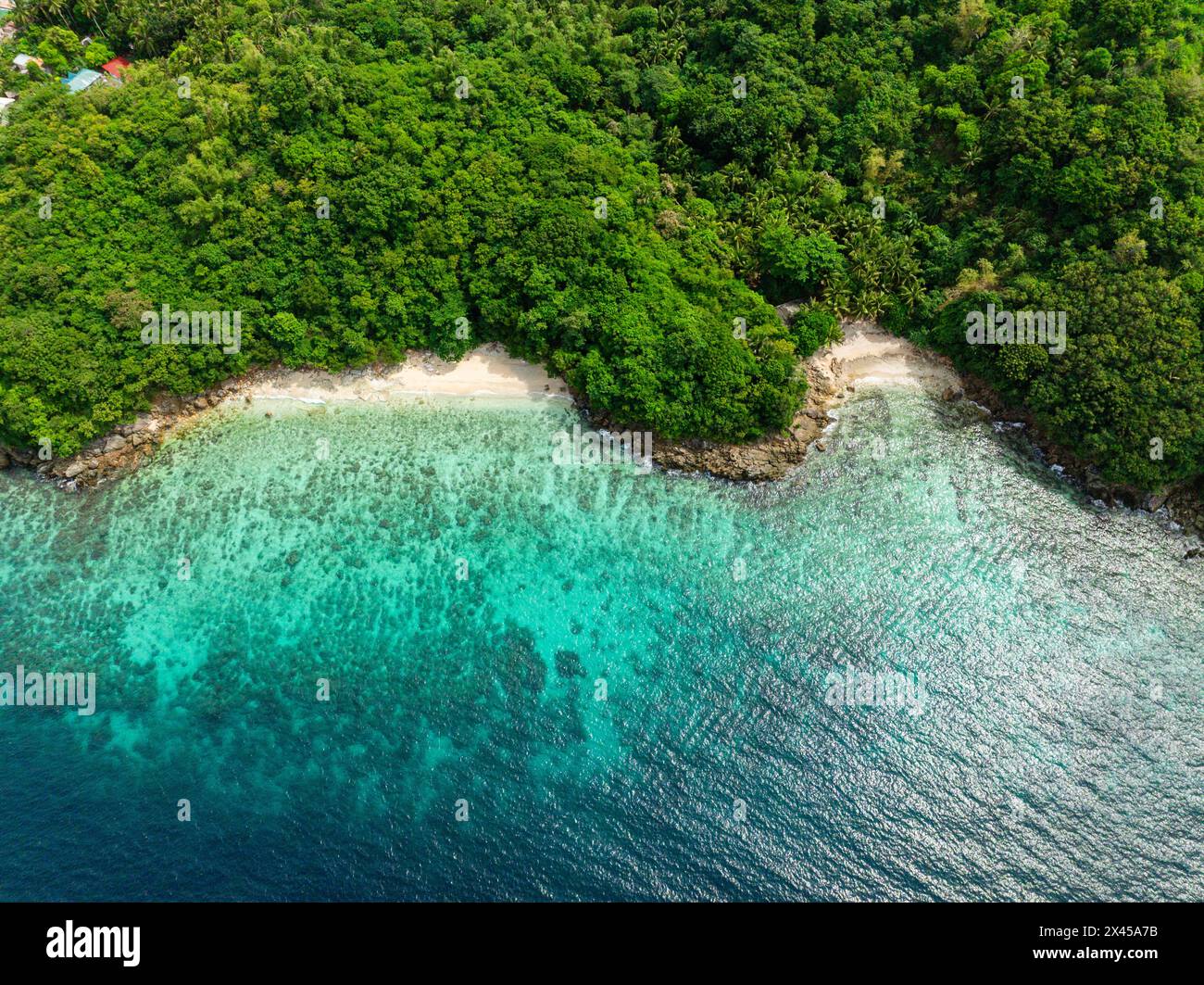 Top view of beach and clear water with sun reflection in Alad Island ...
