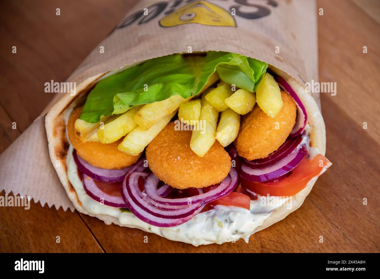 Chicken nugget wrap sandwich bursting with crispy onion, golden French ...