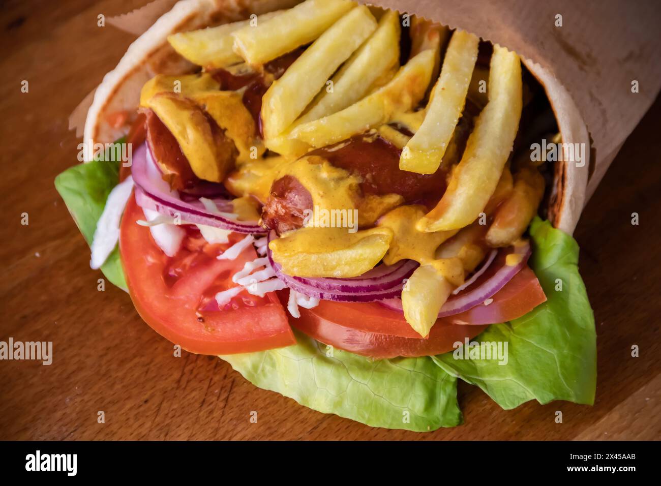flavorful tortilla wrap with savory sausages, French fries, green salad ...