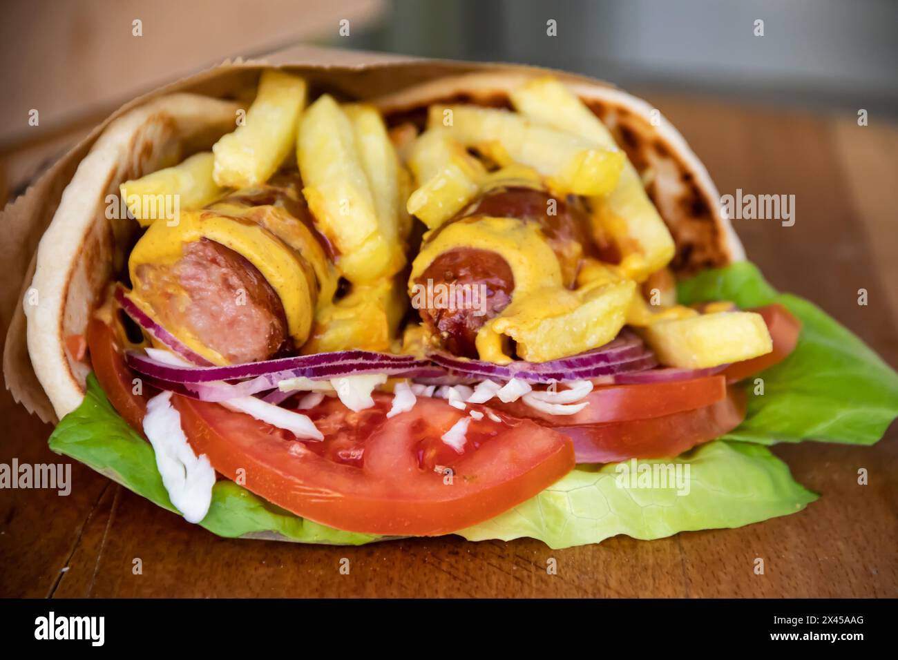 flavorful tortilla wrap with savory sausages, French fries, green salad ...