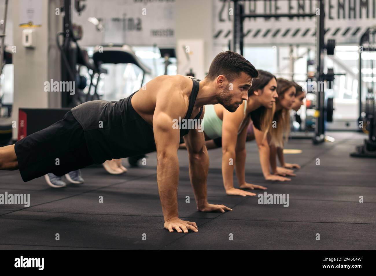 group of young people doing push ups in a gym Stock Photo - Alamy