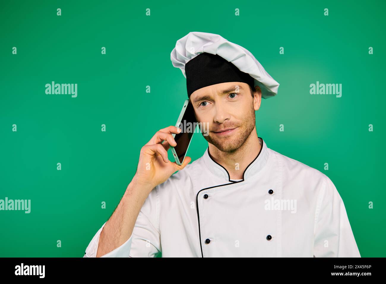 Male chef in white uniform talking on cell phone Stock Photo - Alamy