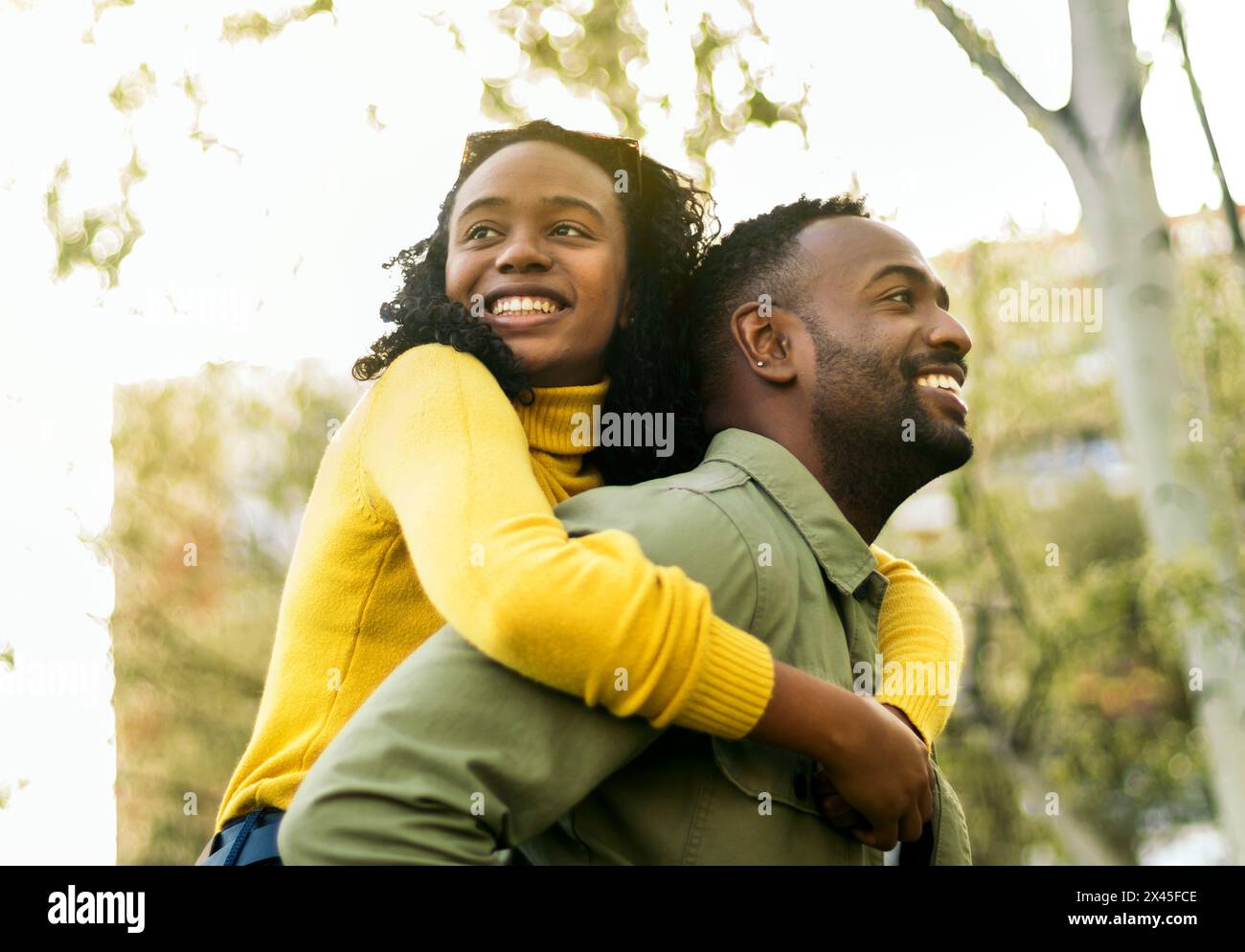 Couple giving piggyback ride children hi-res stock photography and ...