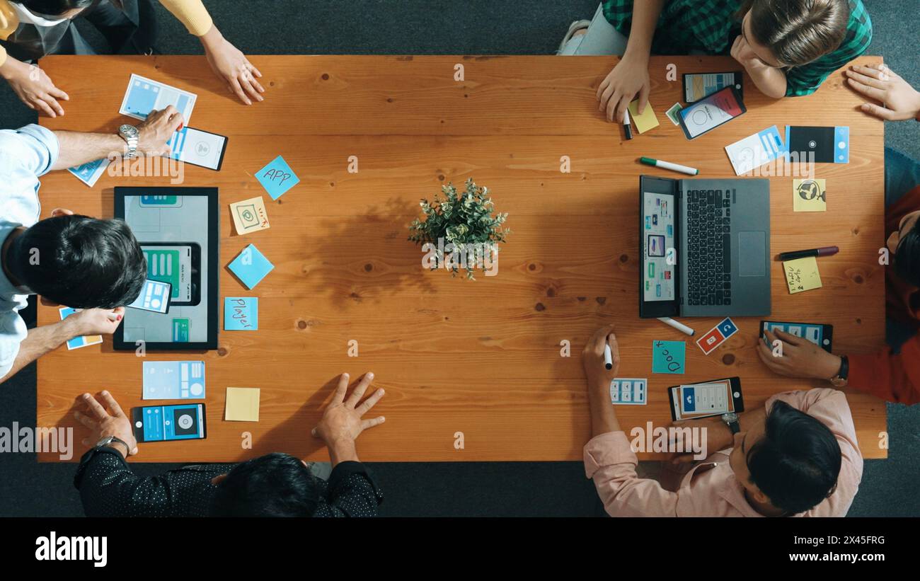 Programmer team brainstorm and plan Ux Ui design for mobile phone while present idea by using ...