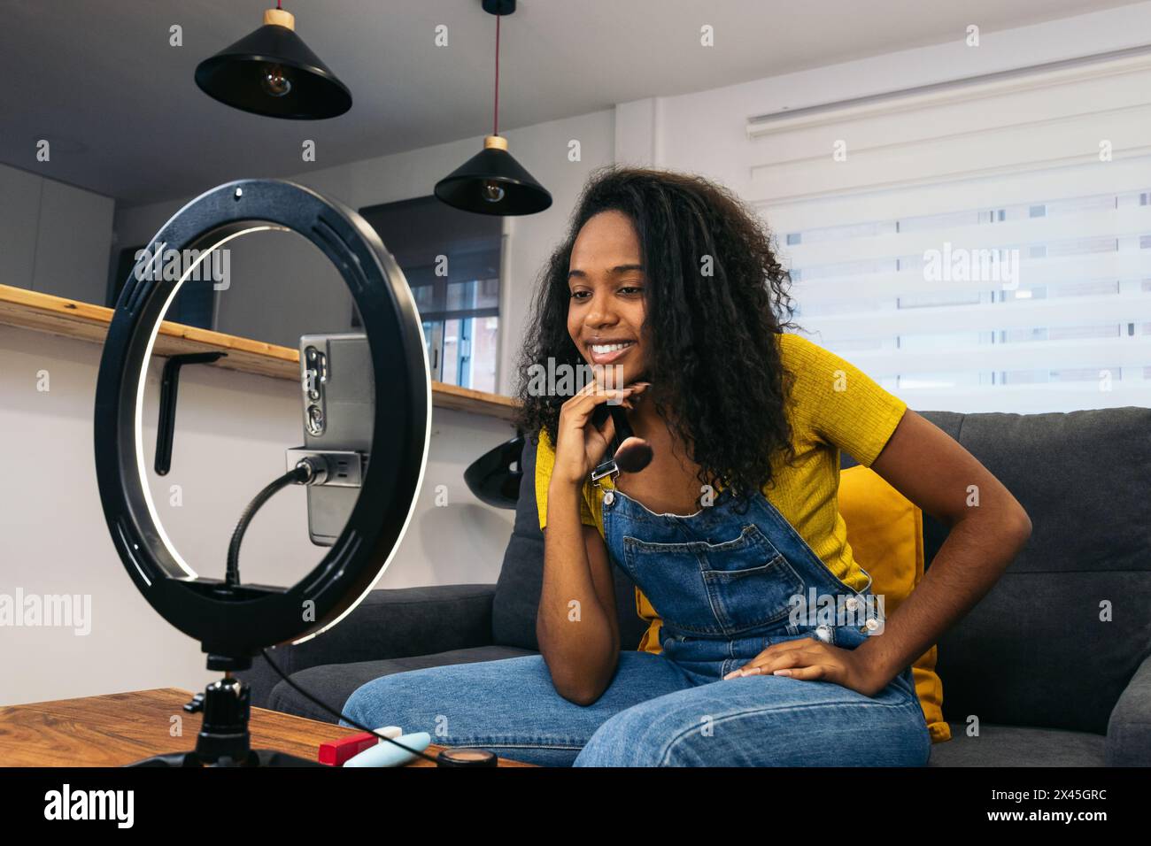 Women recording on smartphone sofa hi-res stock photography and images ...